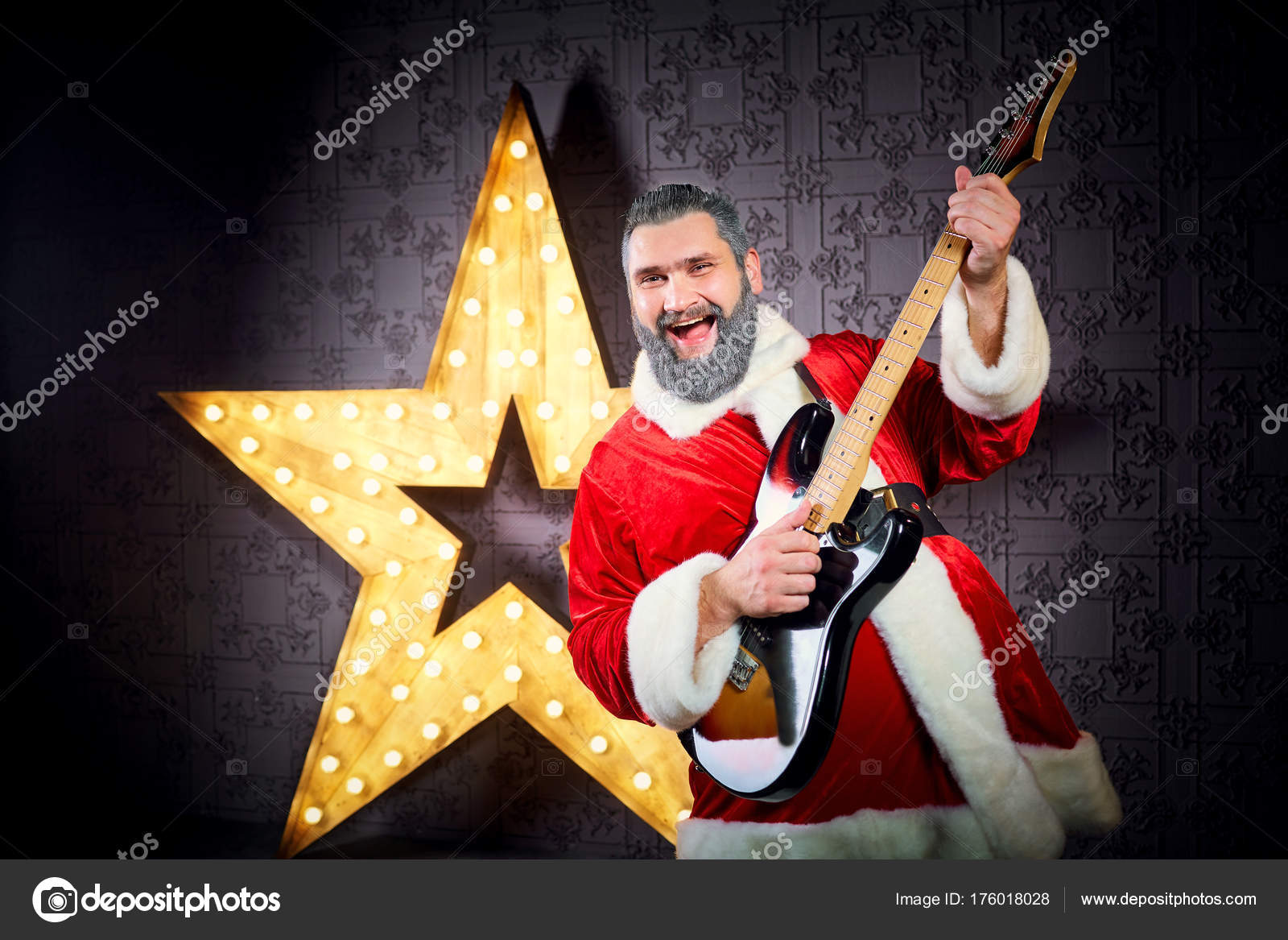 Happy Santa with a guitar is dancing against the background of a Stock ...