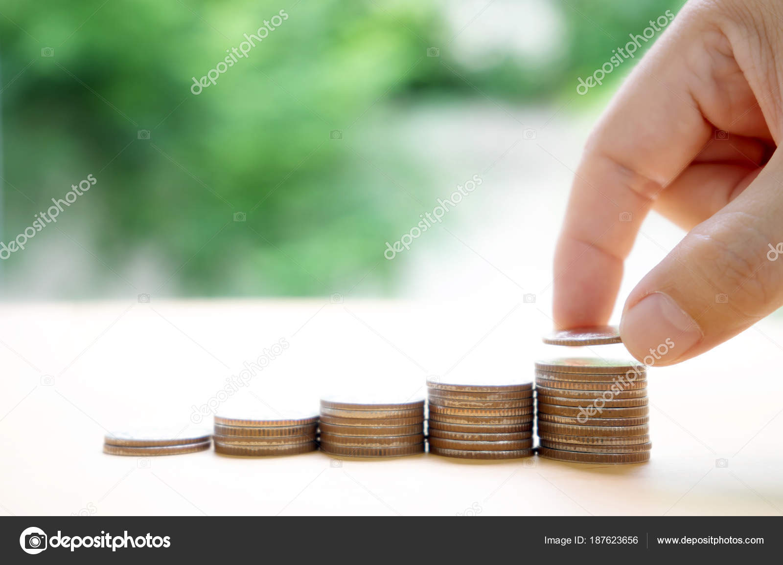 Close Female Hand Stacking Coins — Stock Photo © Ekachailo #187623656