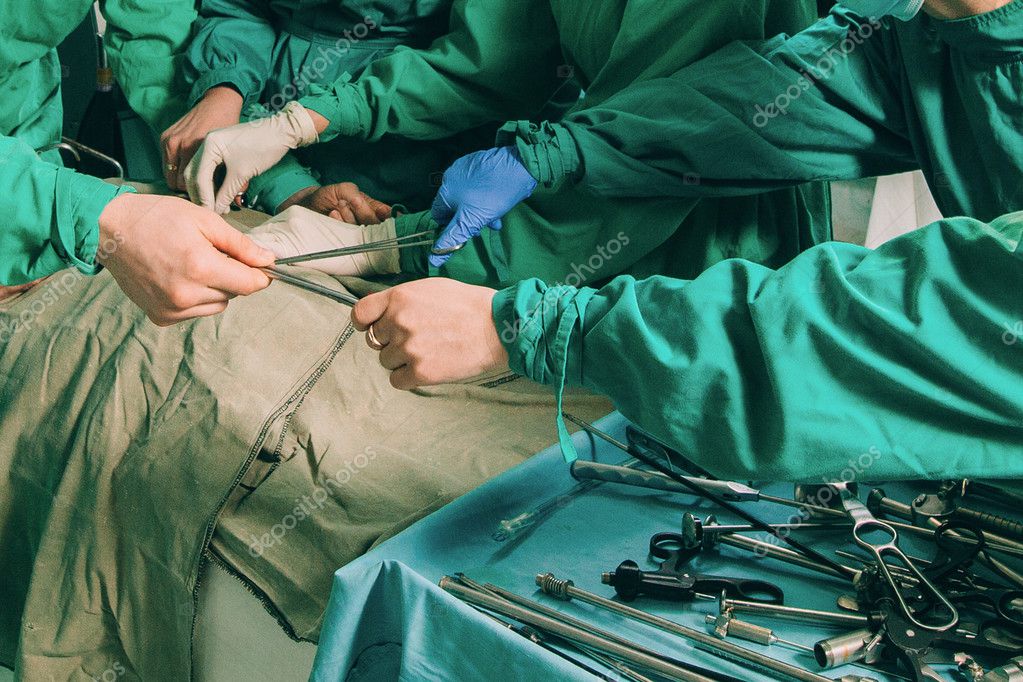 Doctors during surgery operation Stock Photo by ©Amvorsuf 125864192