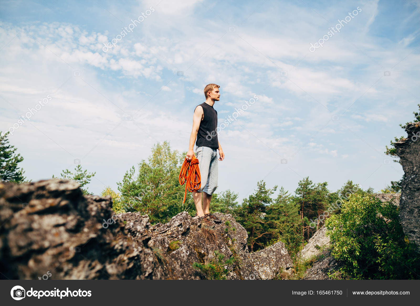 Man standing on rock Stock Photo by ©Amvorsuf 165461750