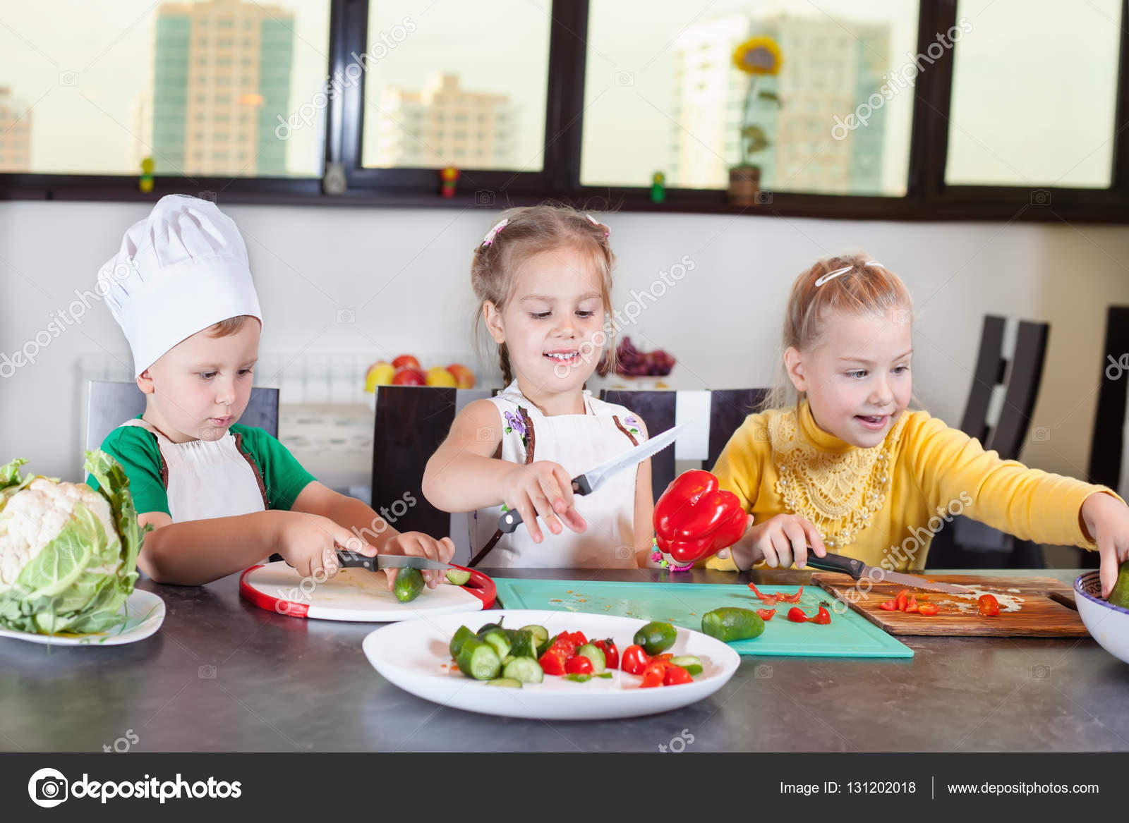 Three cute kids are preparing a salad in the kitchen — Stock Photo ...