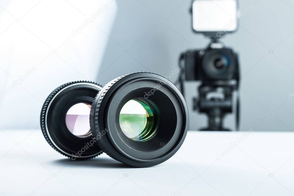 Two lenses on a white table against the background of the camera to ...