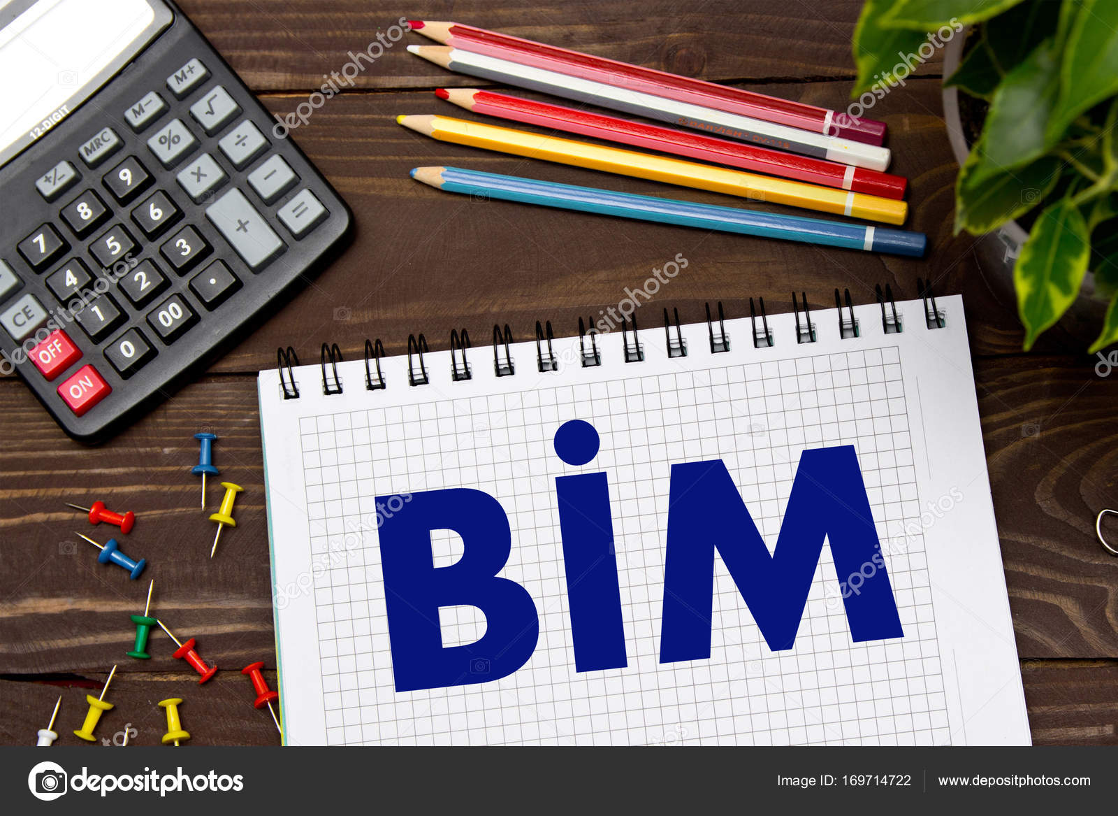 Notebook with a notes BIM on the office table with tools. Concep ...