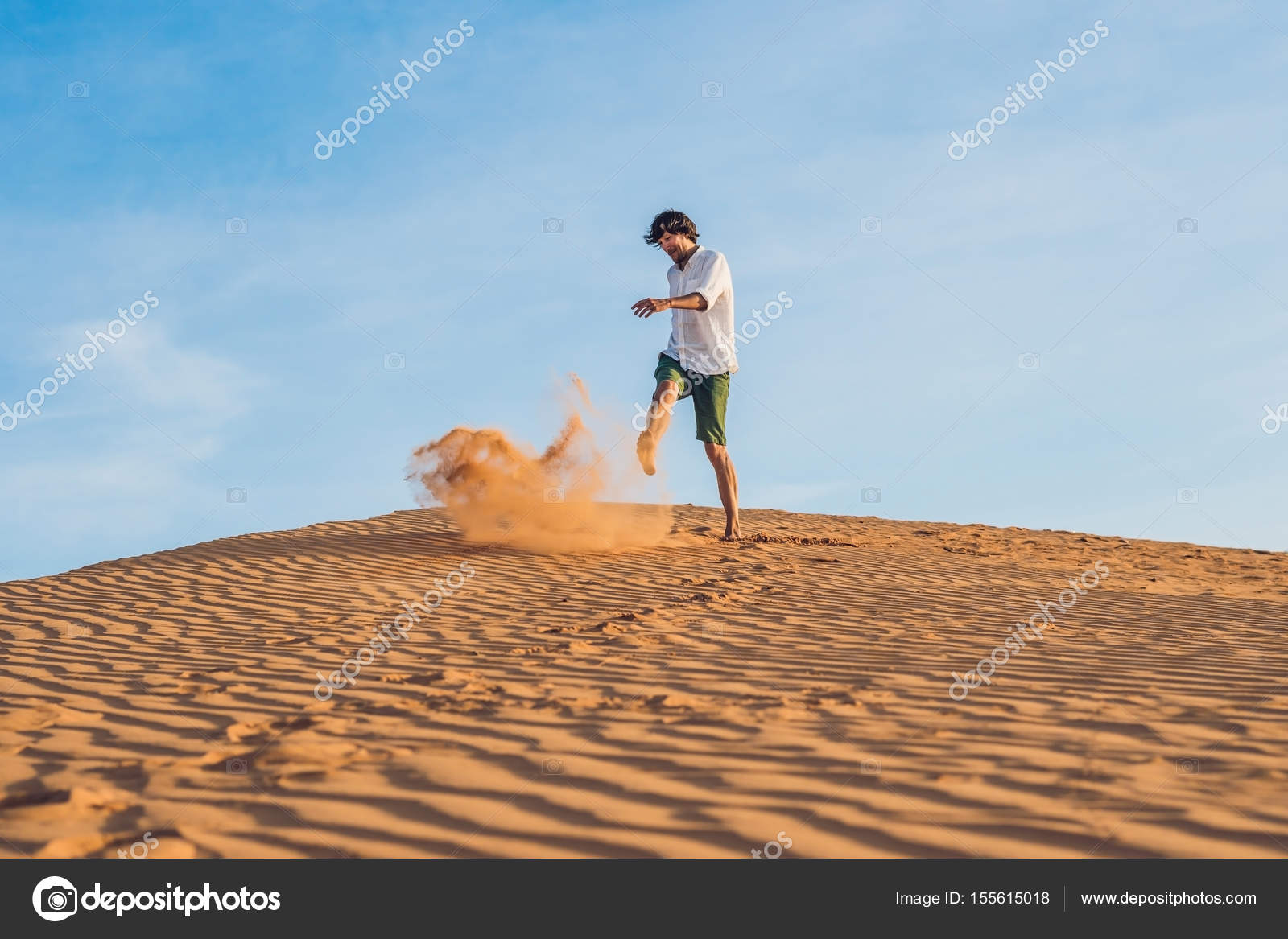 Man is kicking sand in a red desert — Stock Photo © galitskaya #155615018