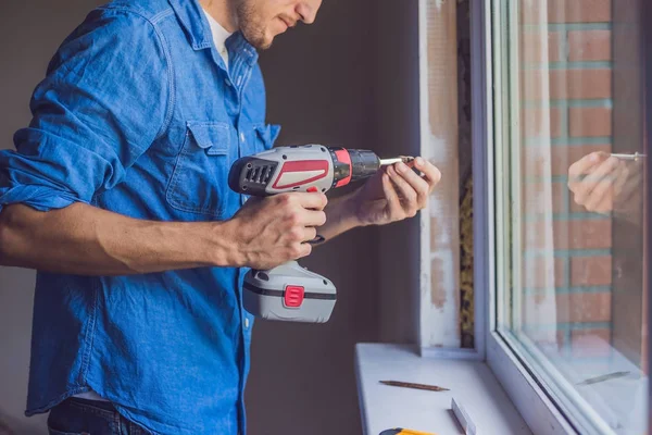 Man does window installation Stock Photo by ©galitskaya 161148360