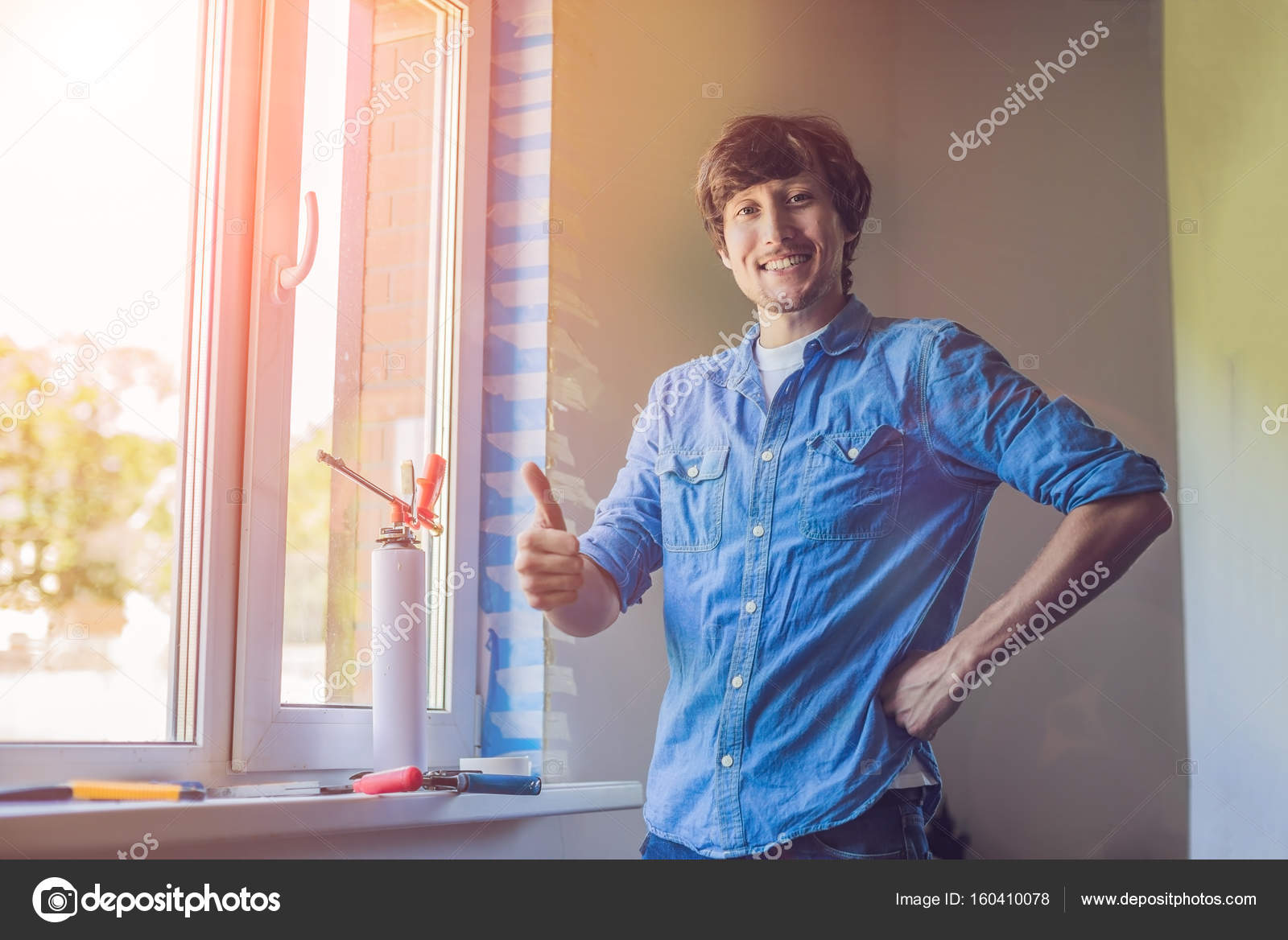 Man in does window installation Stock Photo by ©galitskaya 160410078