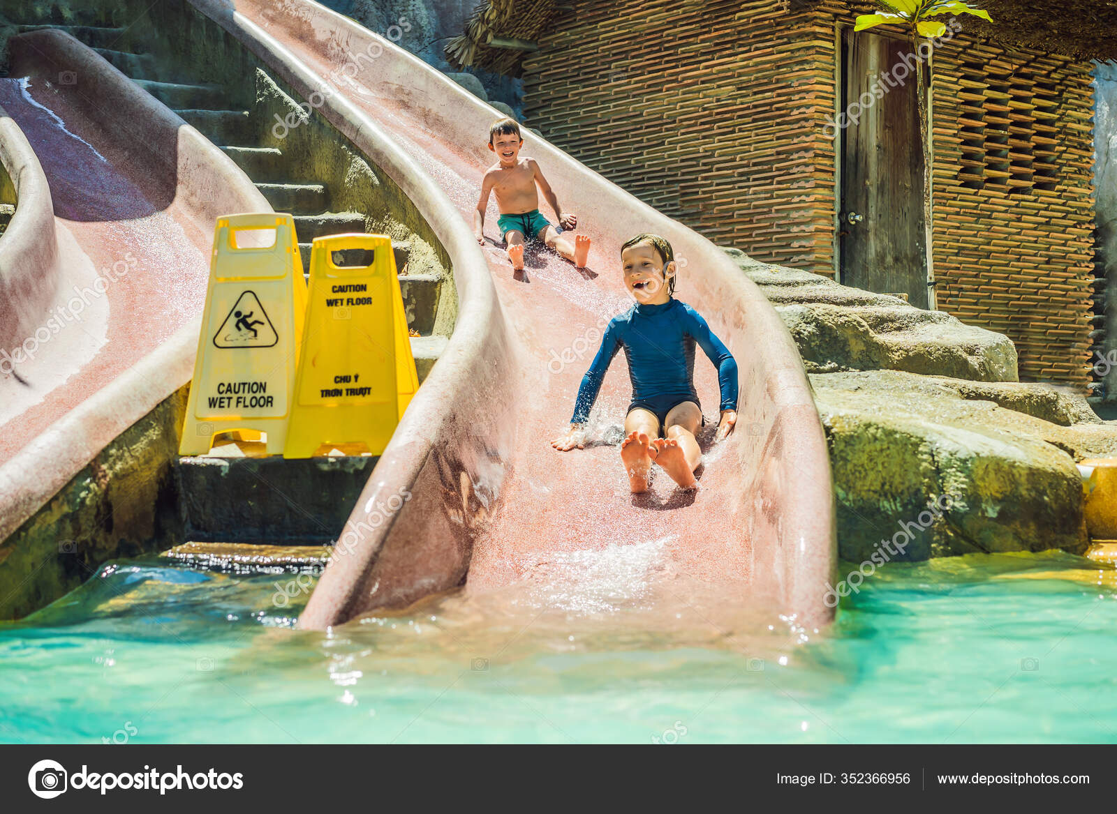 Children ride a water slide in a water park. Happy childhood Stock ...