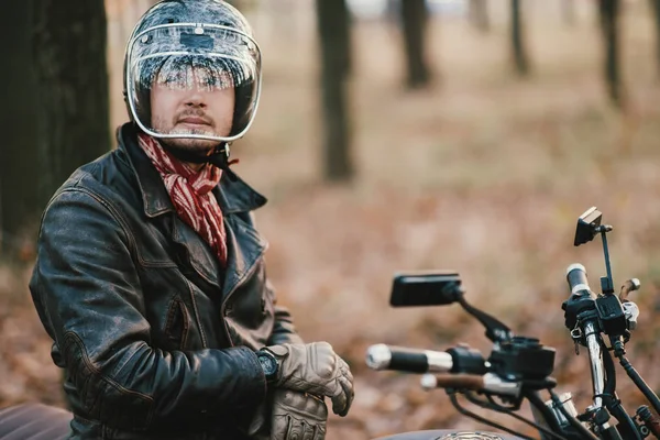 Man and old custom cafe-racer Motorcycle on forest - Stock Image ...