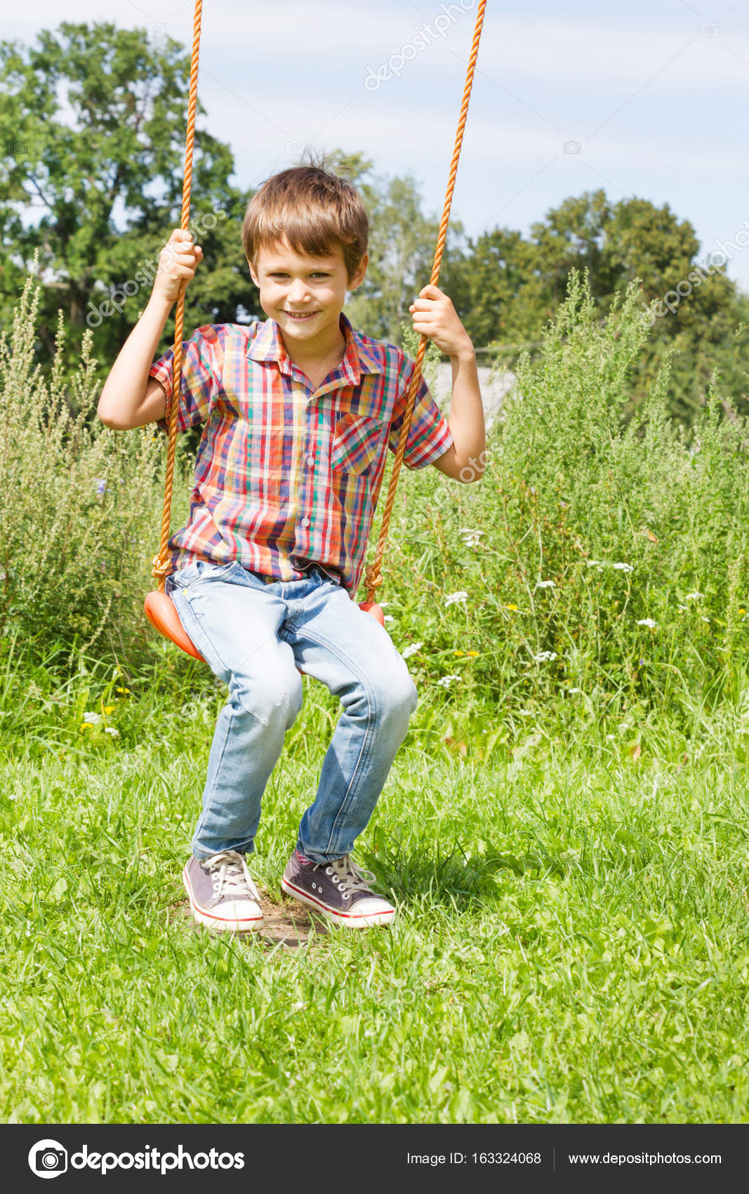 Happy little kid swinging on swing outdoor Stock Photo by ©Vejaa 163324068