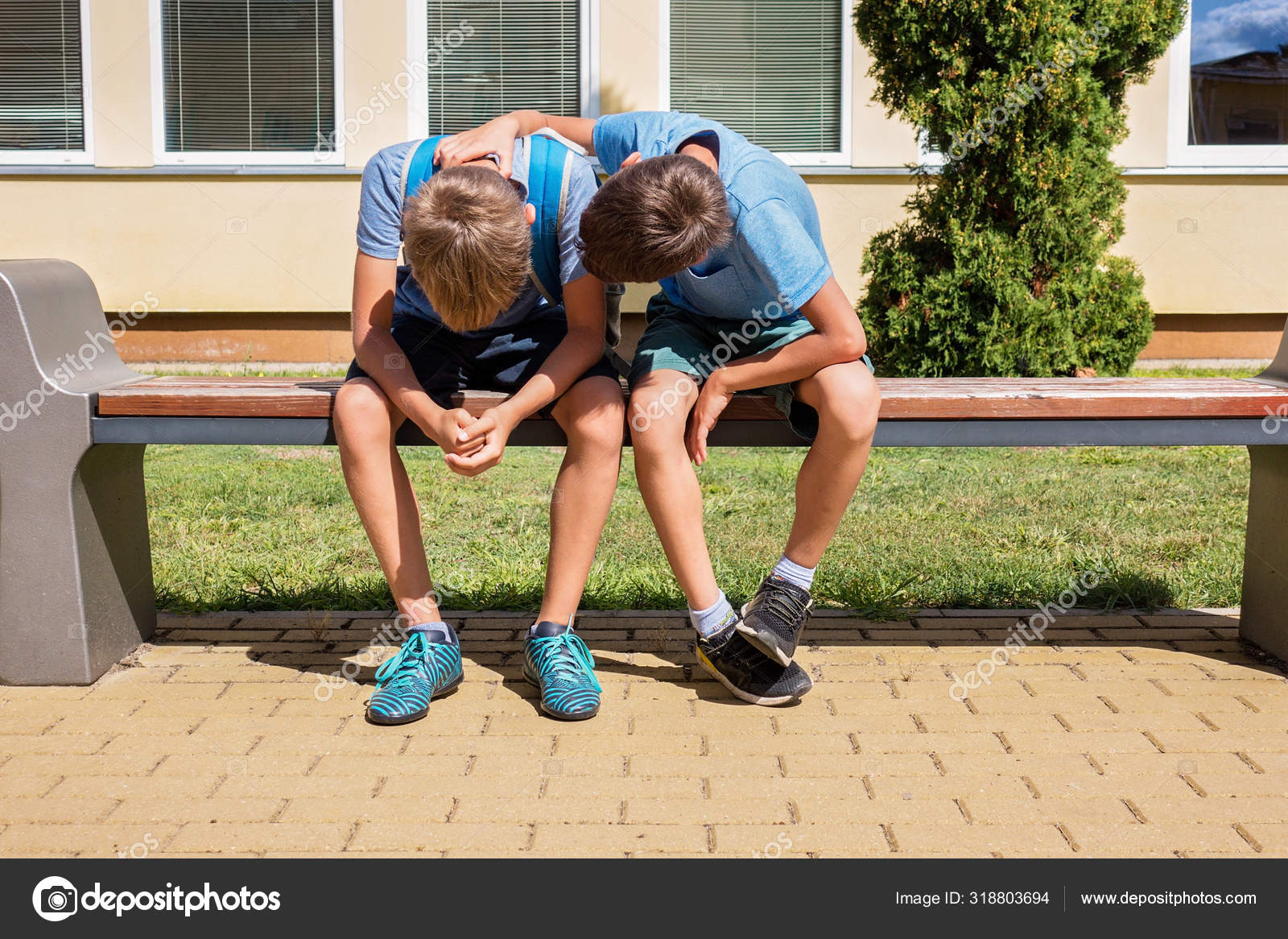 Kid comforting consoling upset sad boy in school yard Stock Photo by ...