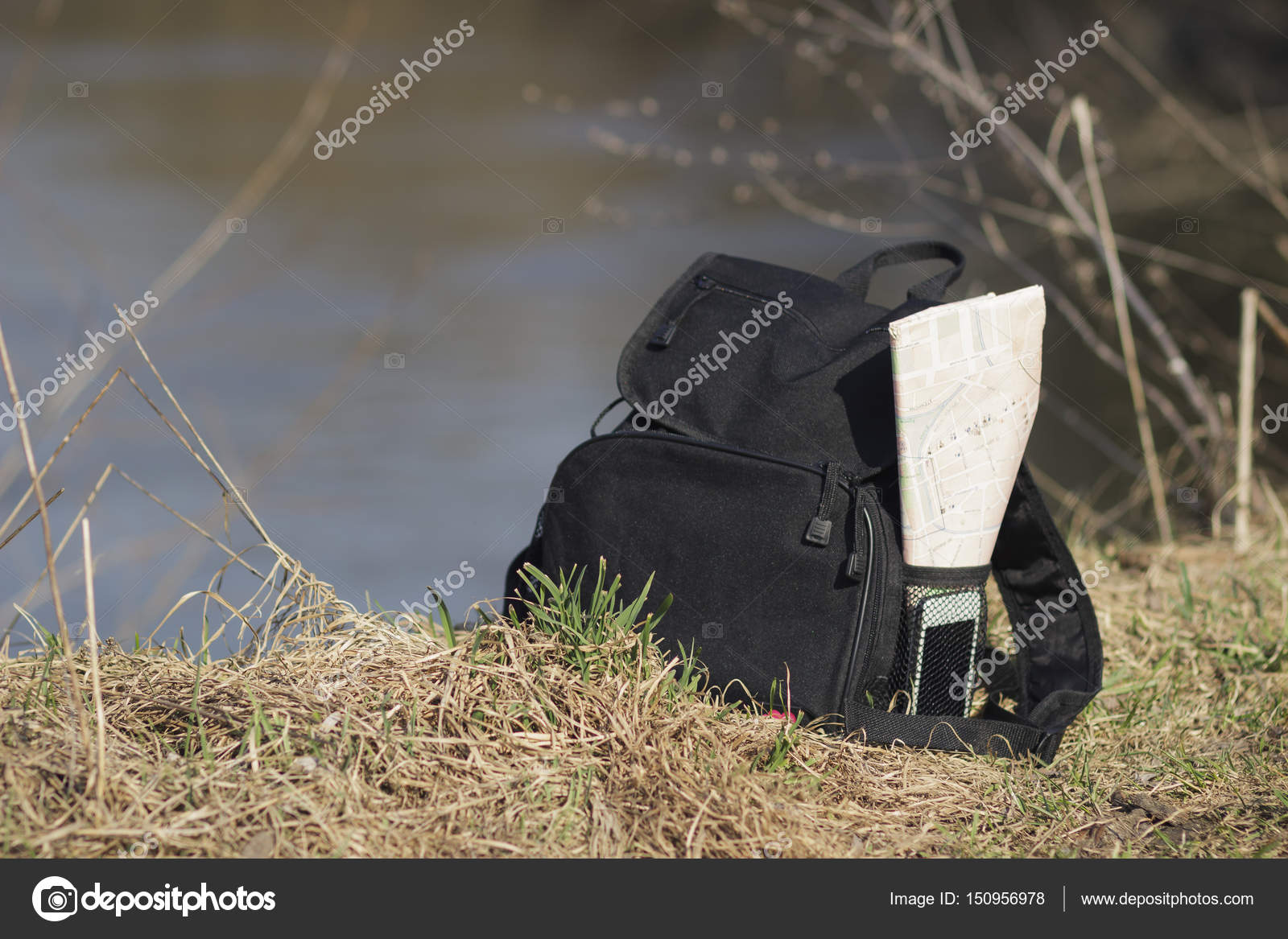 Backpack with phone and map in the pocket on the shore Stock Photo by ...