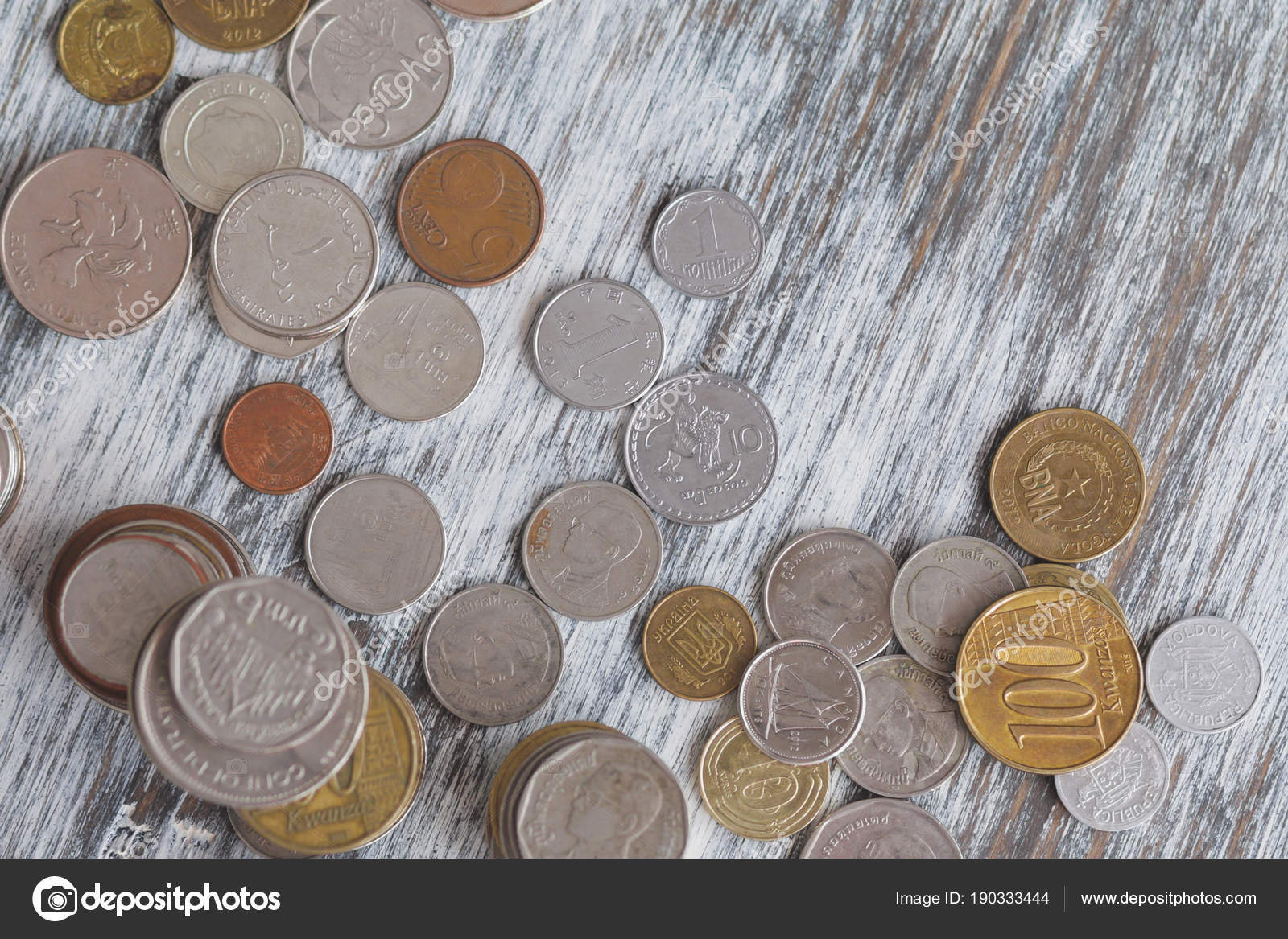 Different collector coins on the wooden background Stock Photo by ...