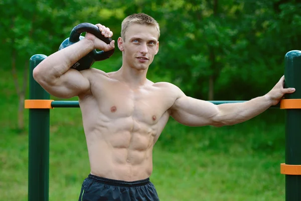 Muscular man practice street workout in an outdoor gym - Stock Image ...