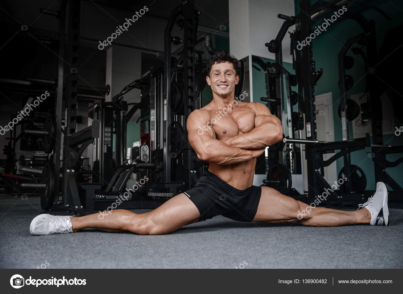 Splits stretches man stretching legs in the gym handsome fitness ...