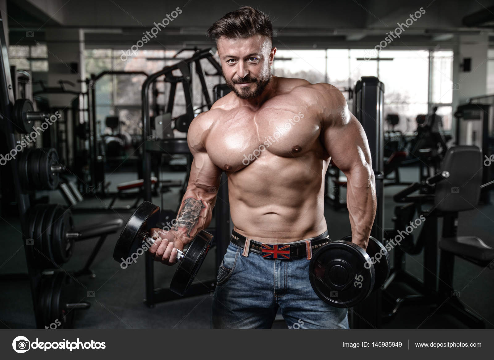 Brutal strong bodybuilder man pumping up muscles and train gym Stock ...