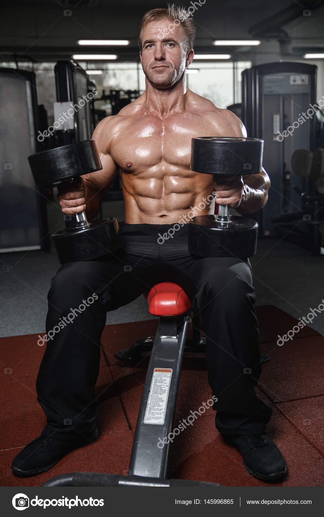 Brutal strong bodybuilder man pumping up muscles and train gym ⬇ Stock ...