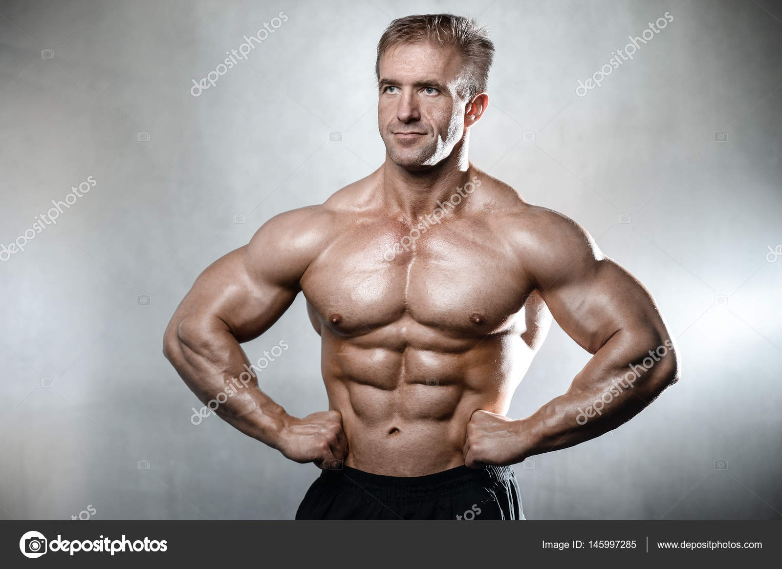 Brutal strong bodybuilder old man posing in studio grey backgrou Stock ...