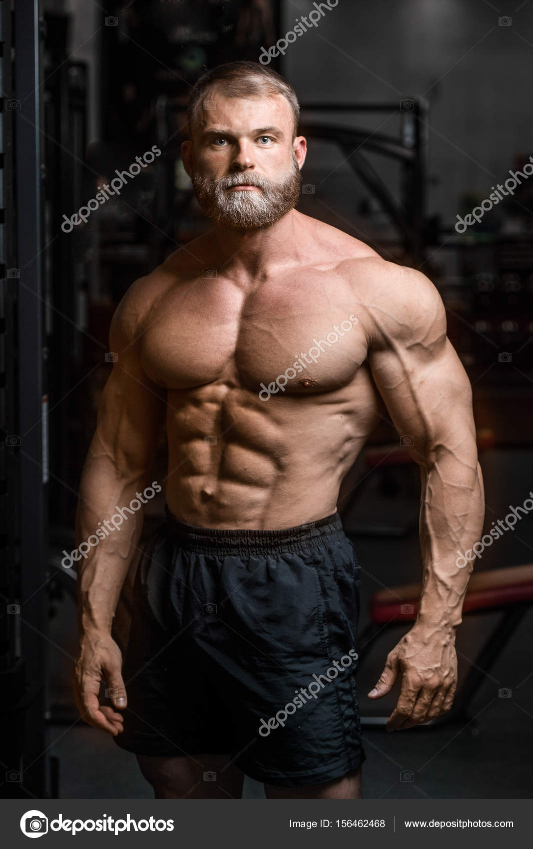 Handsome fit caucasian muscular man flexing his muscles in gym Stock ...