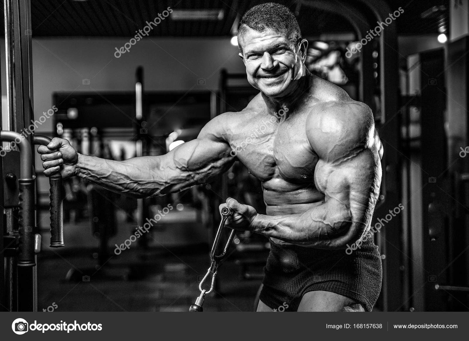 Handsome model young man training arms in gym Stock Photo by ...