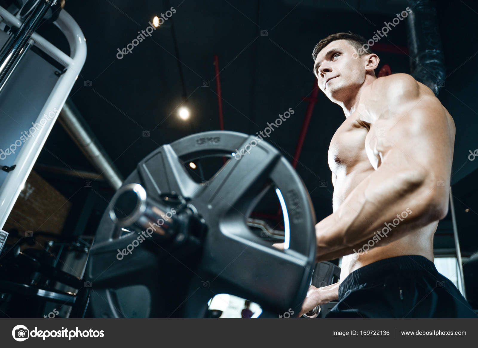 Handsome model young man training arms in gym Stock Photo by ...
