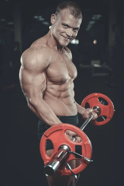 Handsome model young man training arms in gym - Stock Image - Everypixel