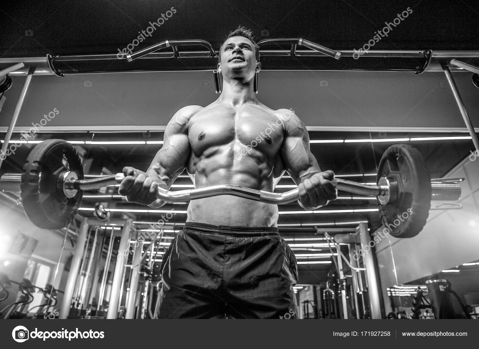 Handsome model young man training arms in gym Stock Photo by ...