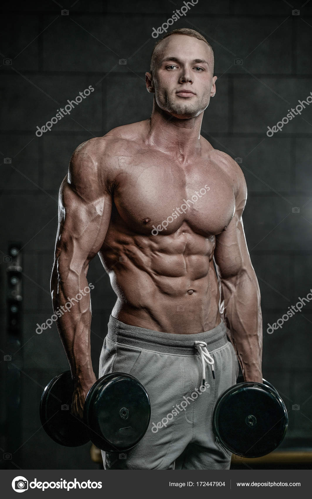 Handsome model young man training abs in gym Stock Photo by ...