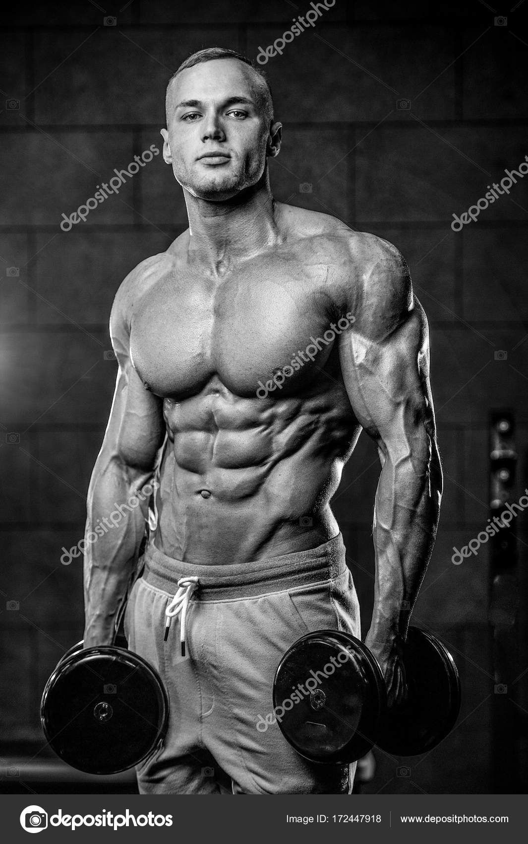 Handsome model young man training abs in gym Stock Photo by ...