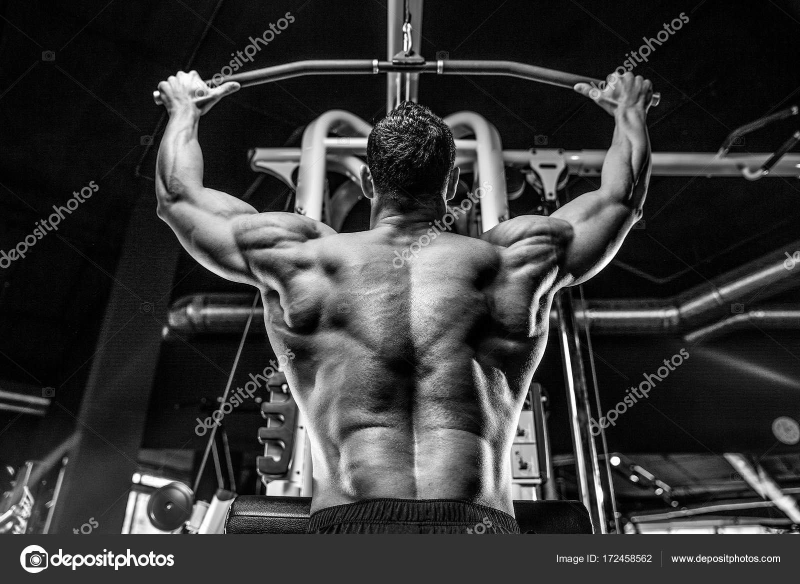 Handsome model young man training back in gym Stock Photo by ...