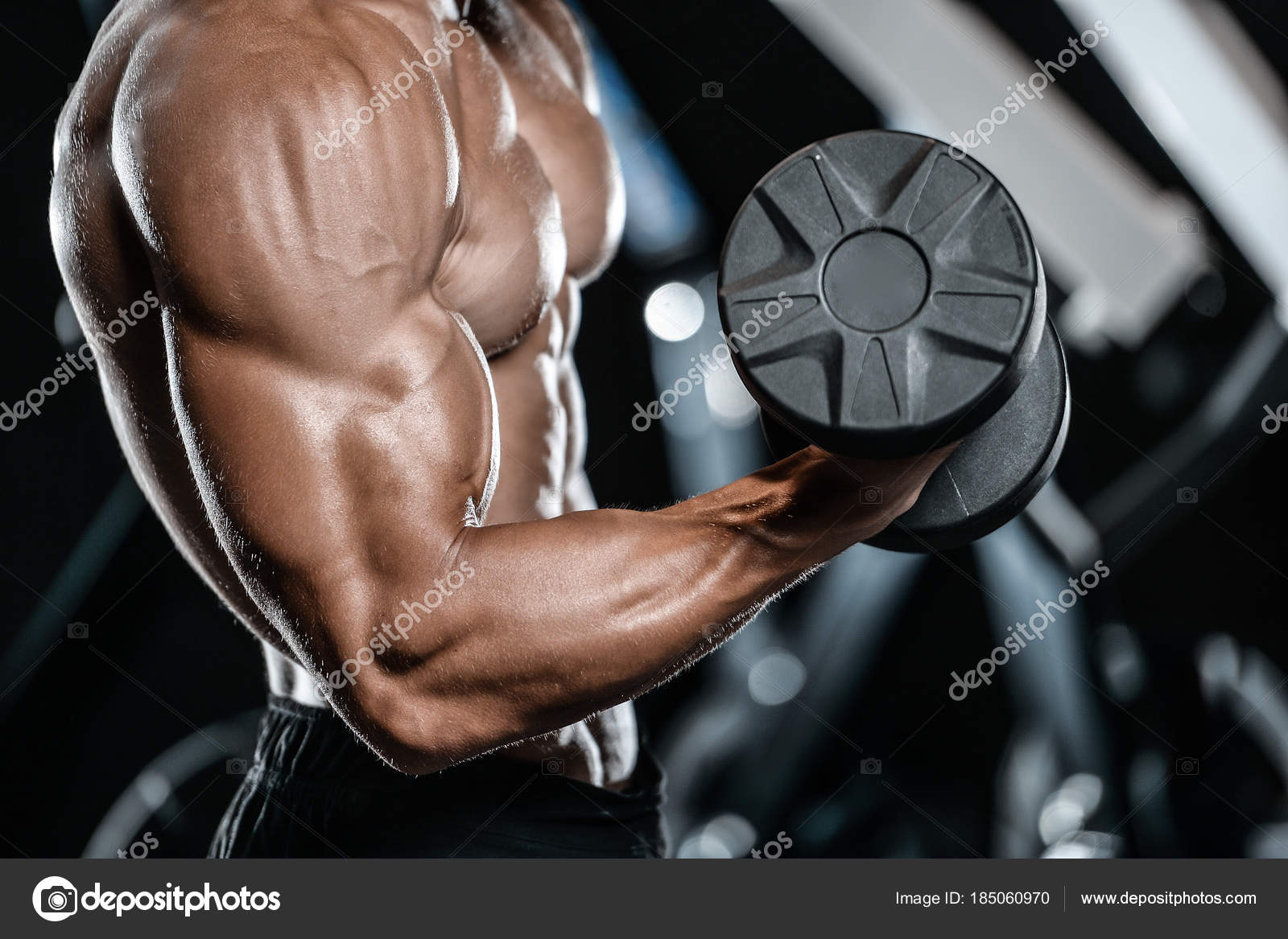 Handsome model young man training arms in gym Stock Photo by ...