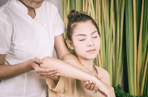 Women Is Getting Shoulder And Elbow Massage In Thai Massage Spa Stock