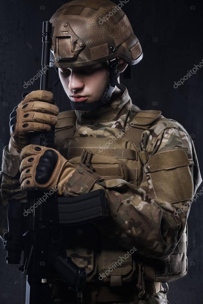Special forces soldier on dark background. Defeat in a difficult fight ...