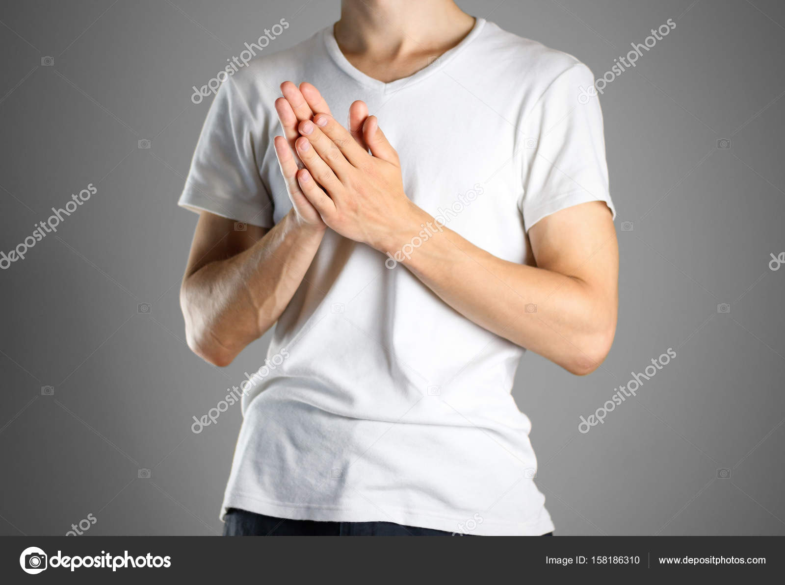 The guy in white t-shirt rubs hand in hand. Rubs the palm of you ...