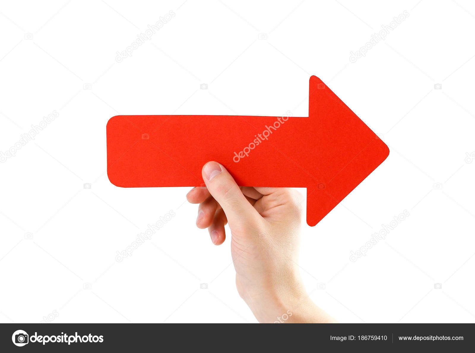 A man's hand holds a large red arrow. Close up. Isolated on a wh ...