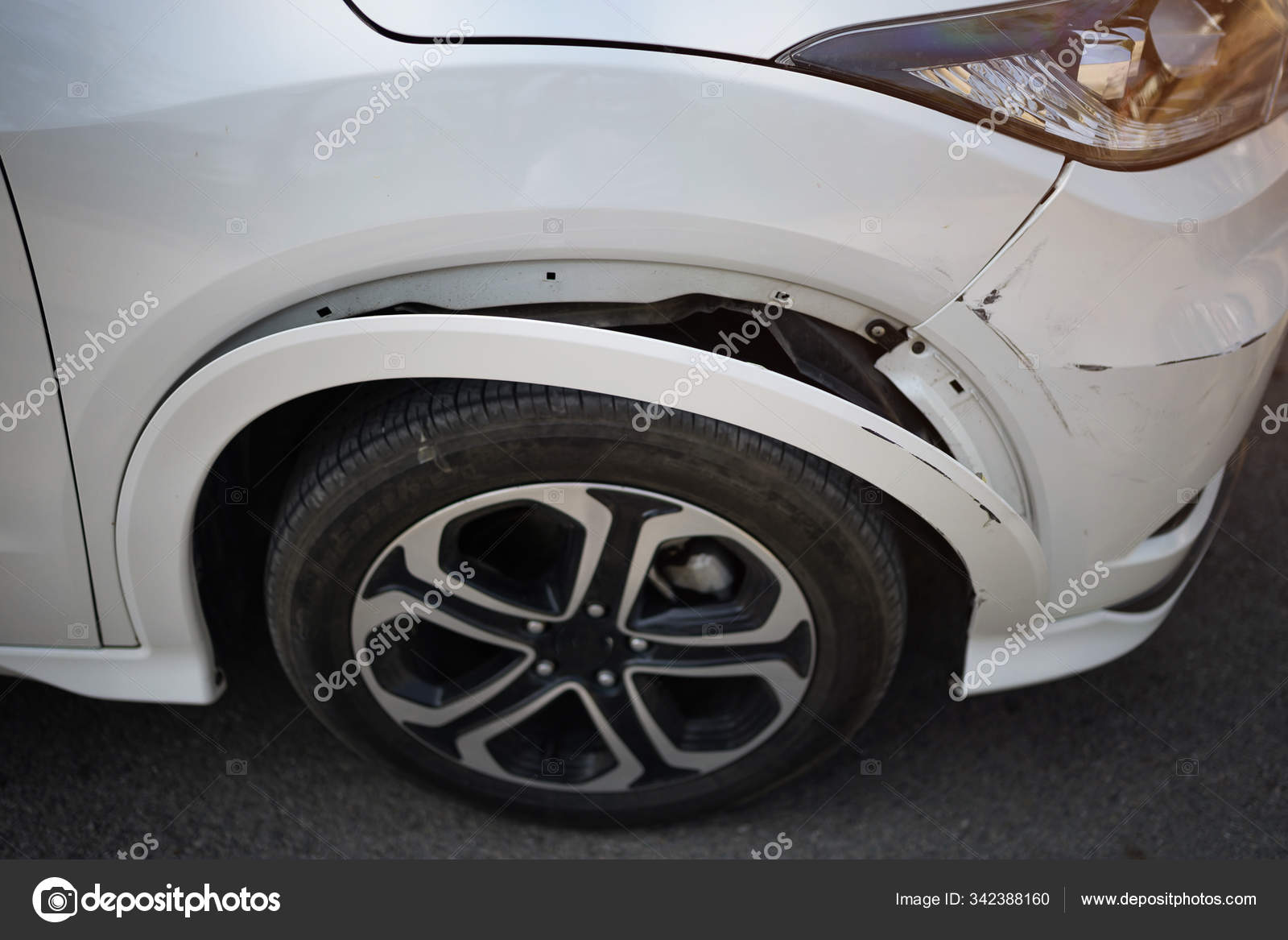 White car has a small bump crash, due to a slight with front-end ...