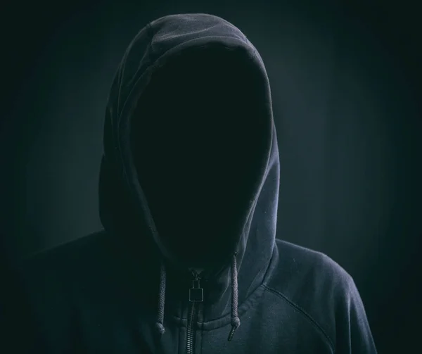 Hooded man on black background - Stock Image - Everypixel