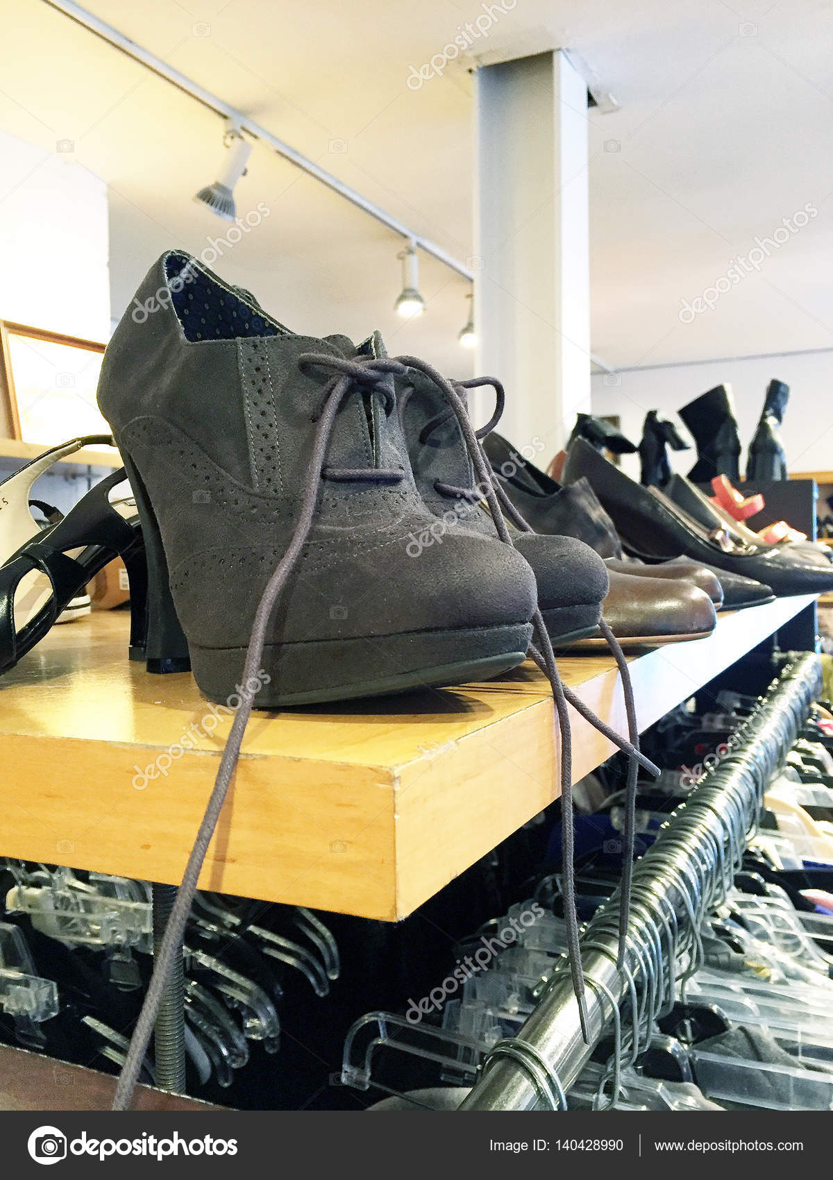 Stylish shoes on top of a clothing rack — Stock Photo © cabecademarmore ...