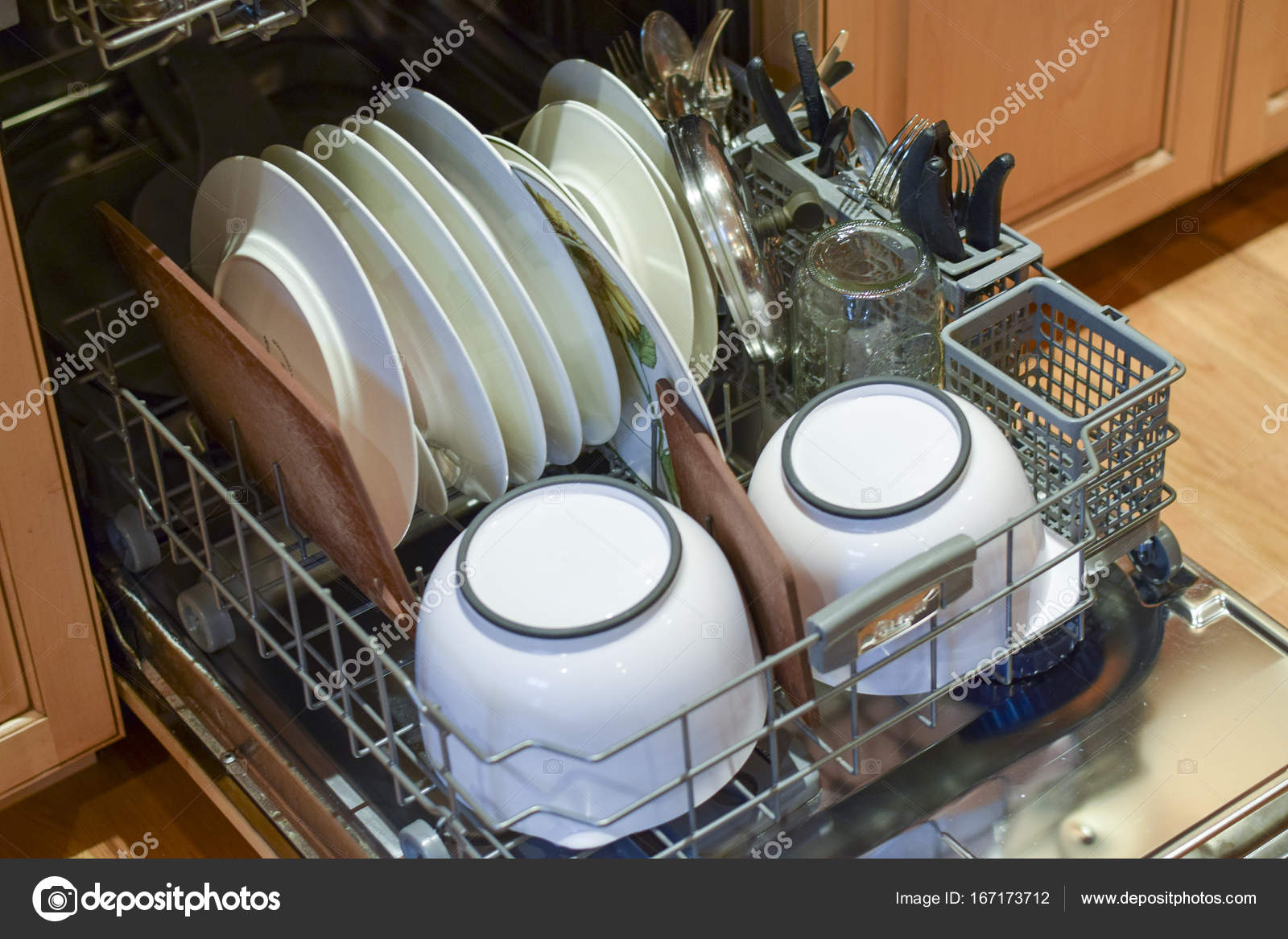 Woman loading dishes and silverware into dishwasher — Stock Photo ...
