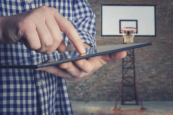Basketball coach using a digital tablet on the basketball court - Stock ...