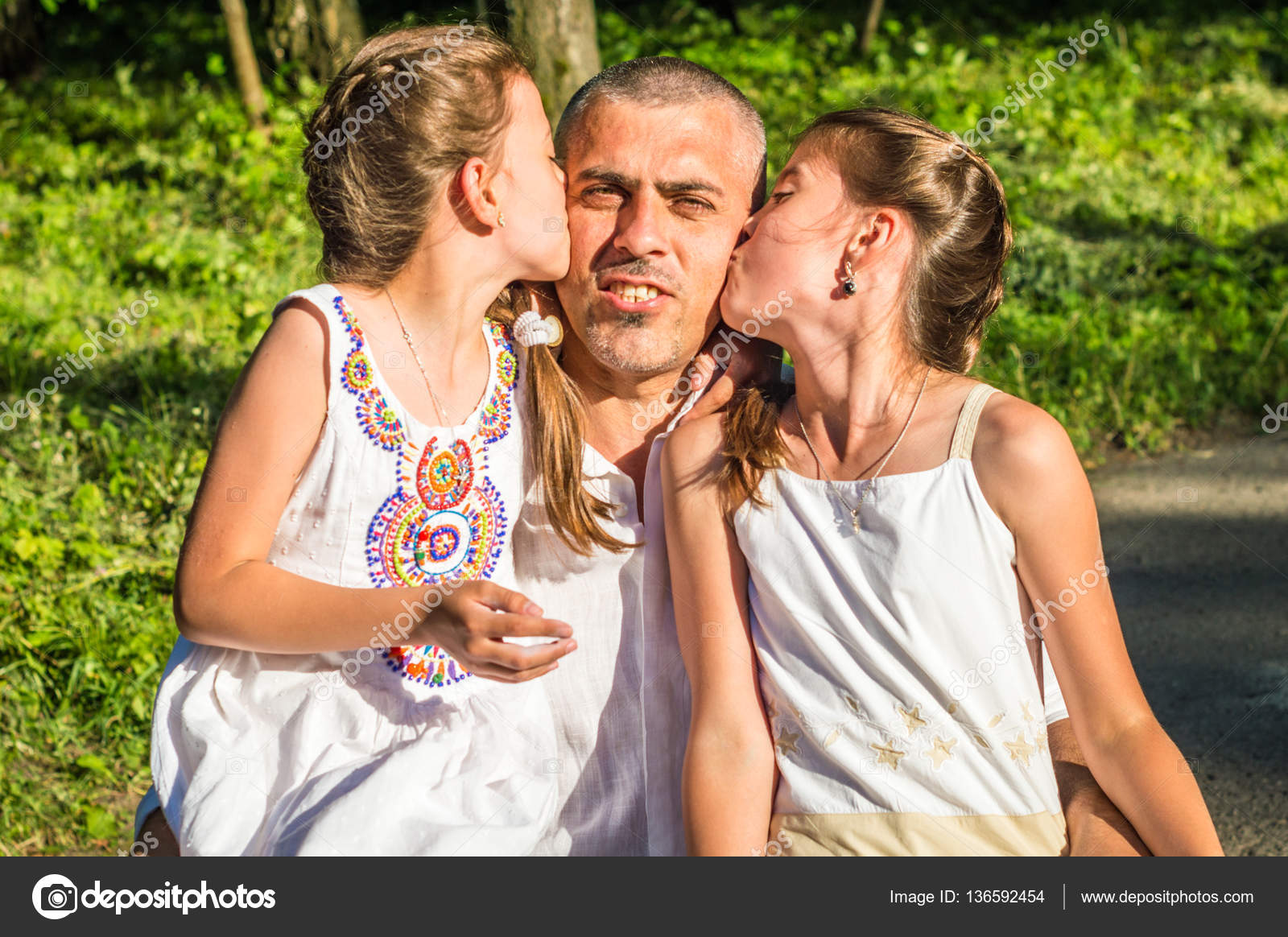 Daddy hugs his daughters — Stock Photo © okskukuruza #136592454 Daddy hugs his daughters — Stock Photo © okskukuruza #136592454