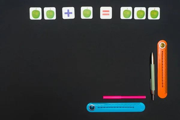 Black art table with stationery supplies with text self educate on ...