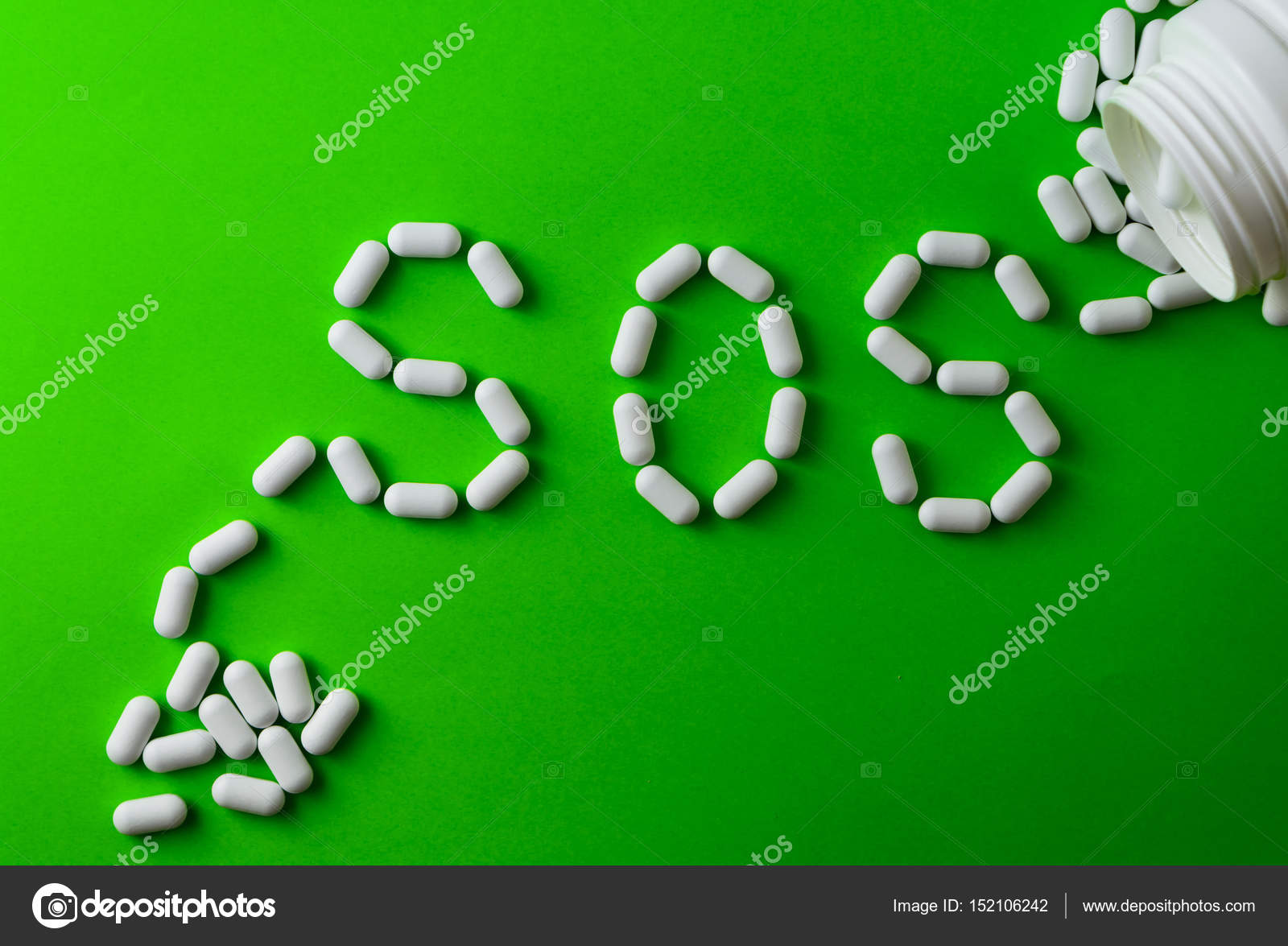 White pills on green background, which forming the word - SOS, with a ...