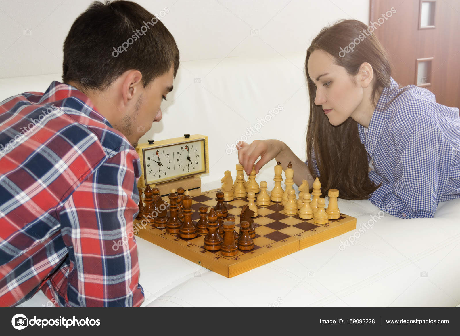 Relaxed young couple playing chess at home lying on sofa. won - Friendship. — Stock Photo ...