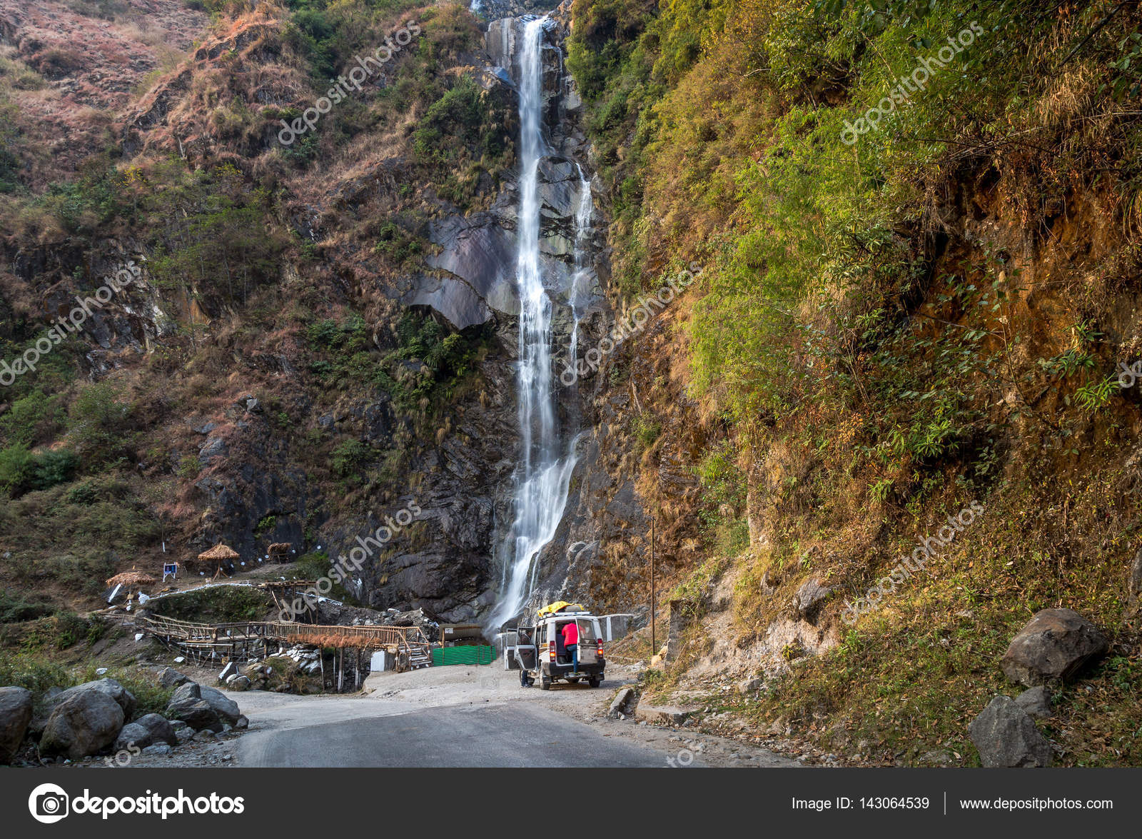Bhim Nala waterfall surrounded by mountains and dense foliage- a ...