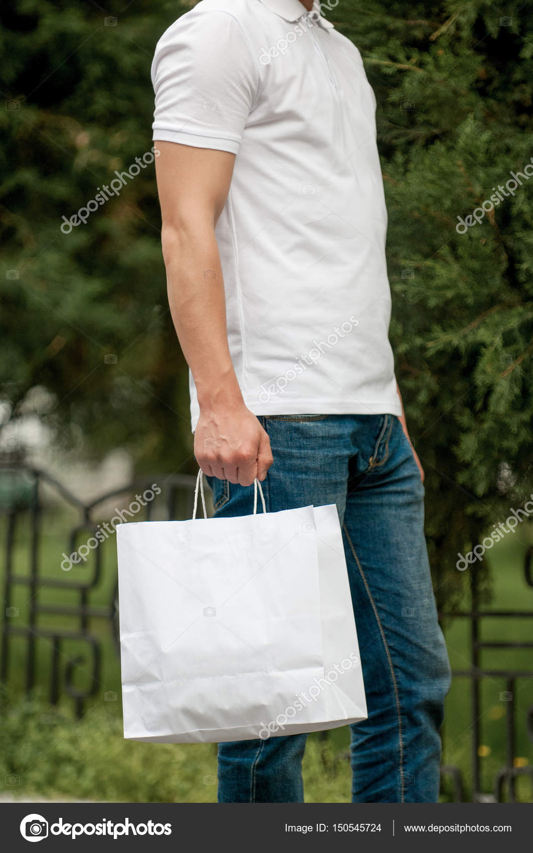 Man with a white package in his hands Stock Photo by ©WarlokA 150545724