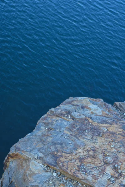 Stone rocks near water, on the background of lake, river, sea, ocean ...
