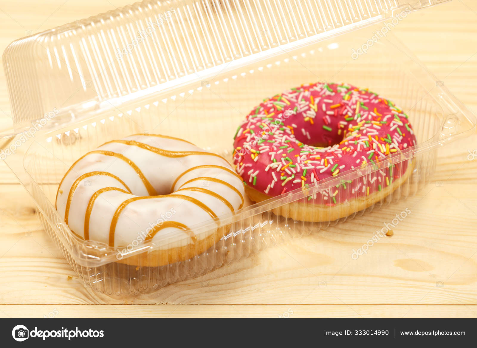 Two glazed doughnuts in plastic packaging — Stock Photo © PNK68 #333014990