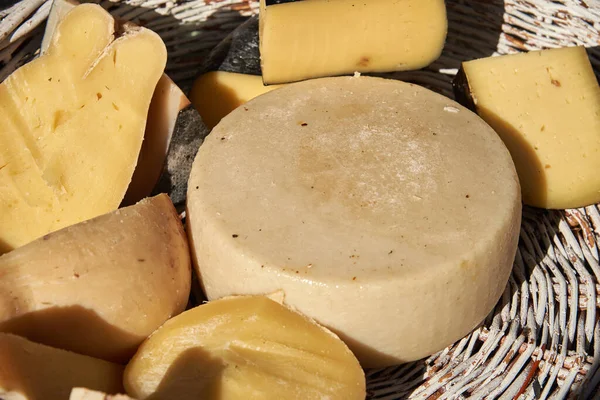 Different varieties of craft cheese in a wicker basket - Stock Image ...