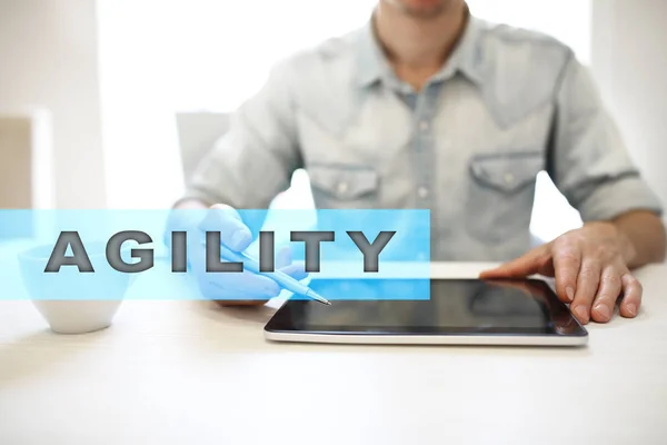 Agility text on virtual screen. Business technology and internet ...