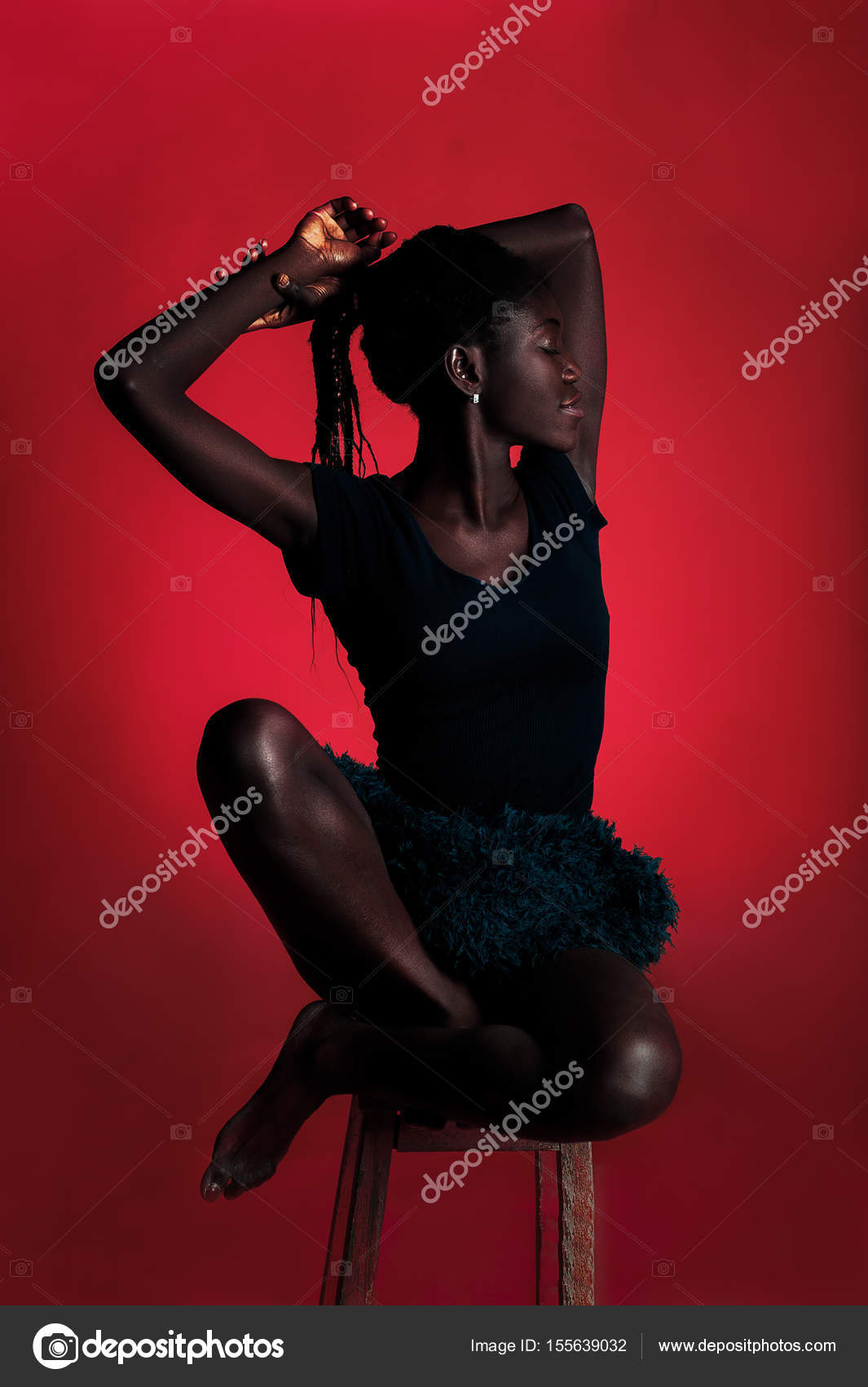 Dark skin model on the red background Stock Photo by ©vergor 155639032